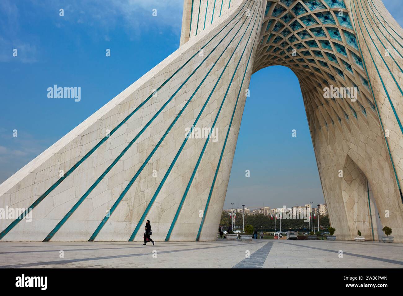 Woman walks at the Azadi Tower (Freedom Tower), an iconic landmark in ...