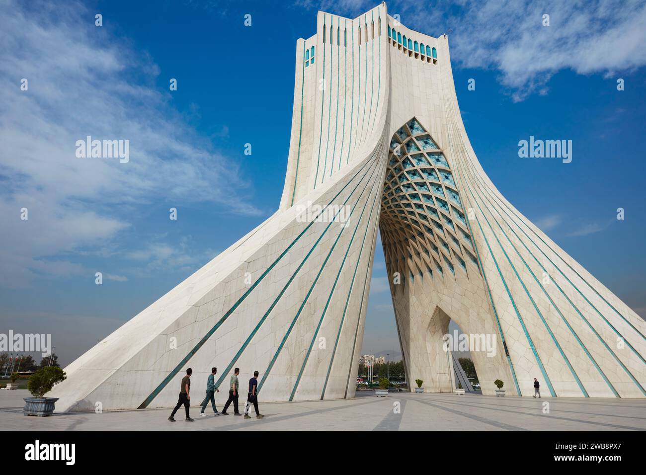Men walk at the Azadi Tower (Freedom Tower), an iconic landmark in ...
