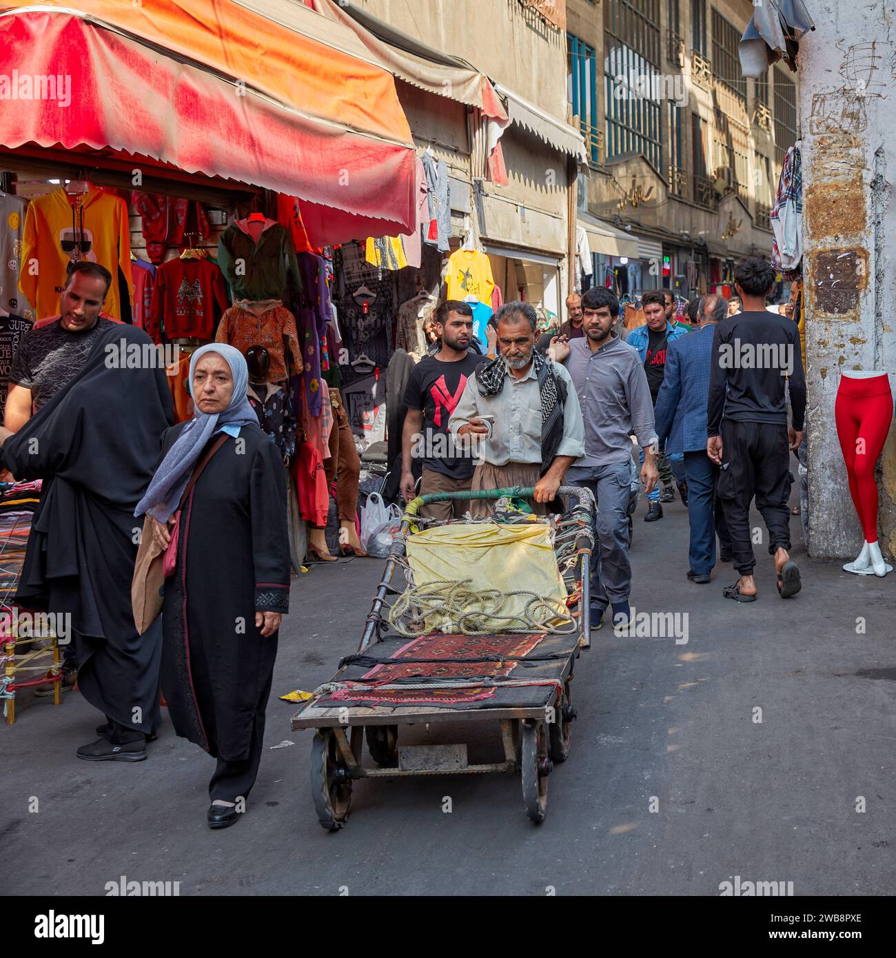 Local people walk along a narrow street in the Grand Bazaar area in ...