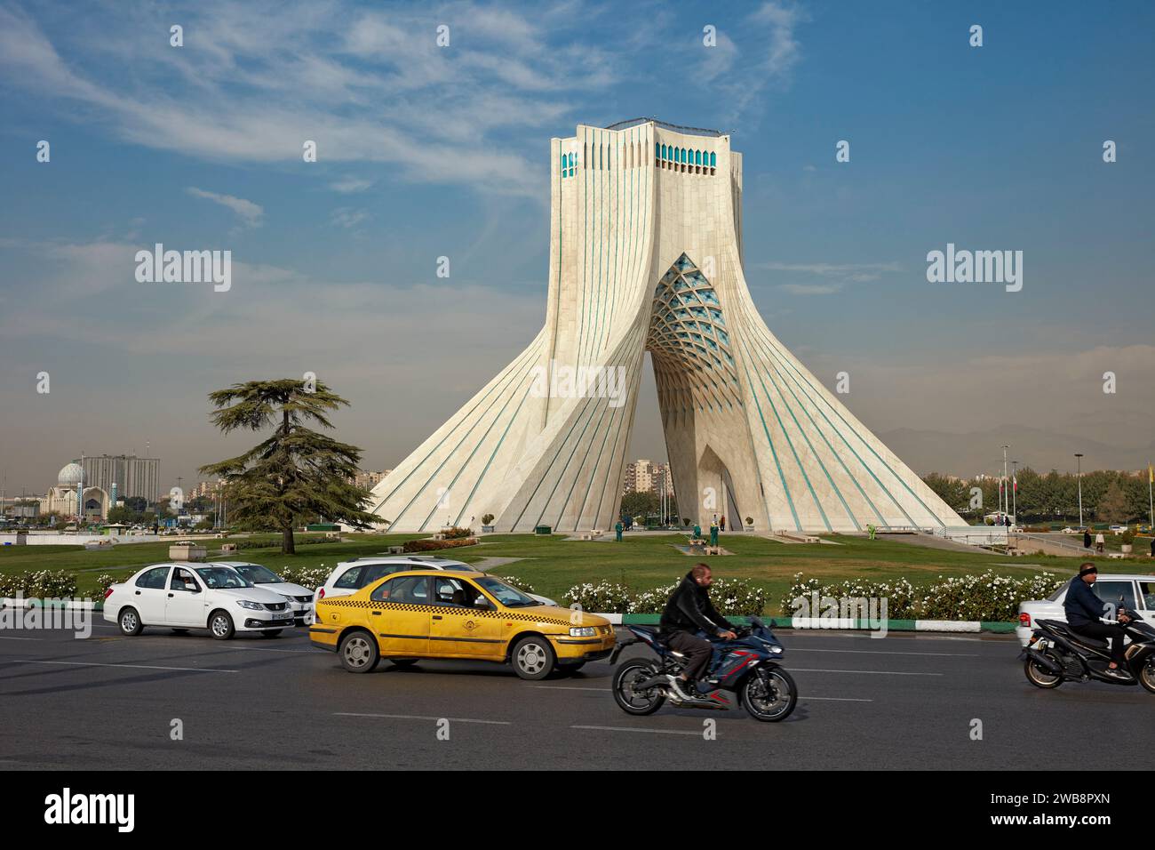 Street traffic in front of the Azadi Tower (Freedom Tower), an iconic ...