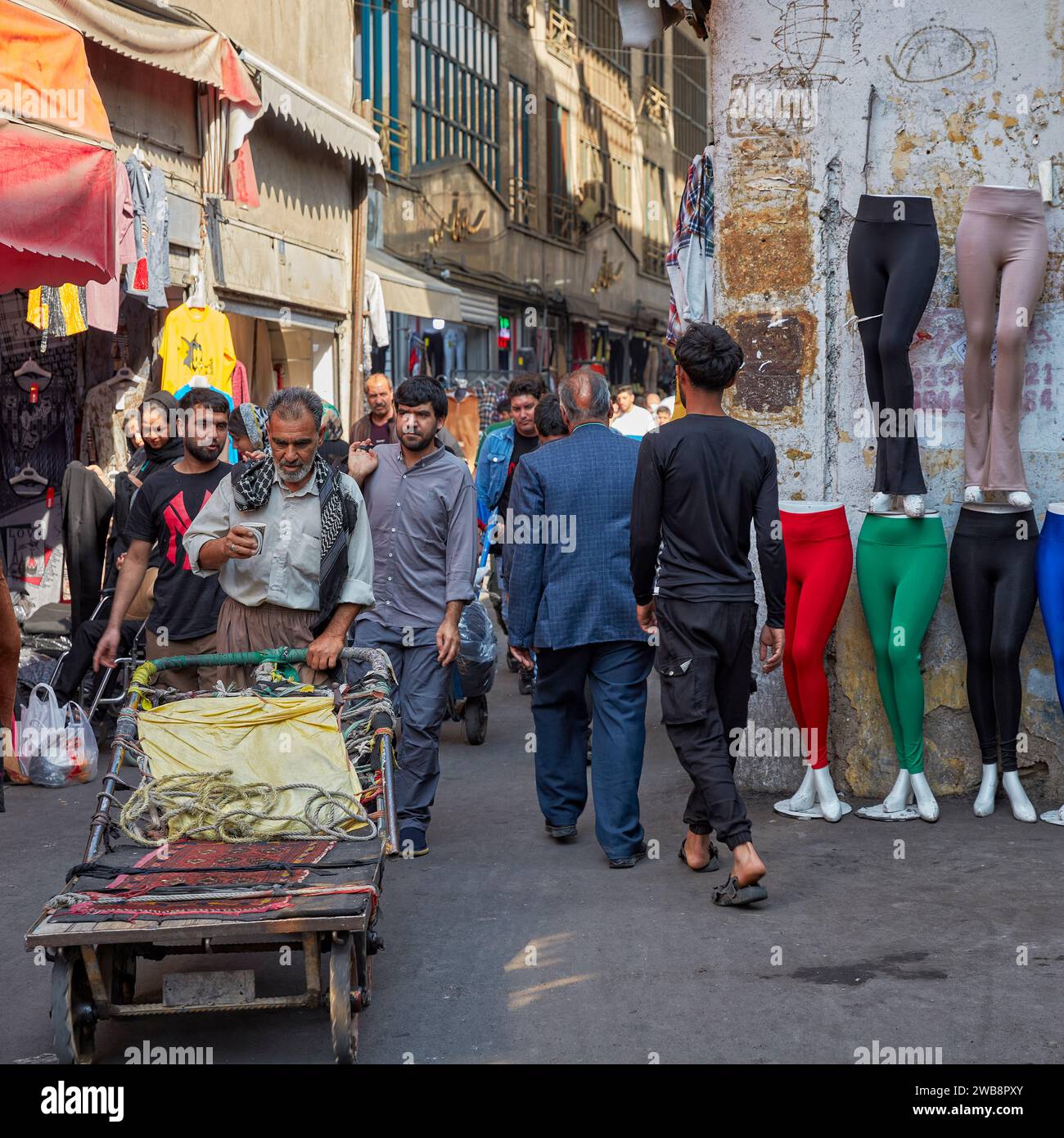 Porter pushes his unloaded cart along a narrow street in the Grand ...