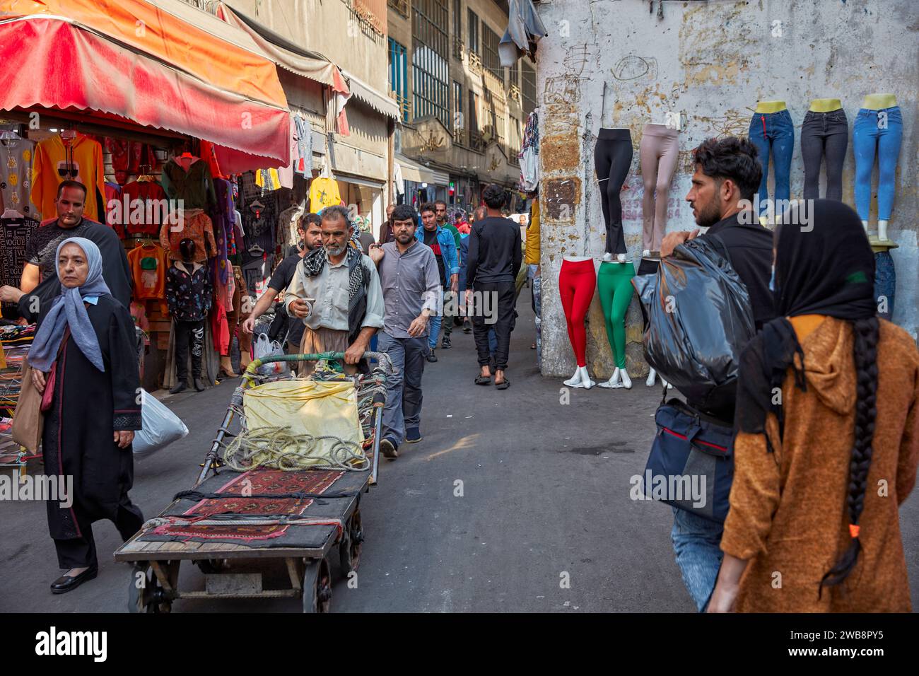 Porter pushes his unloaded cart along a narrow street in the Grand ...