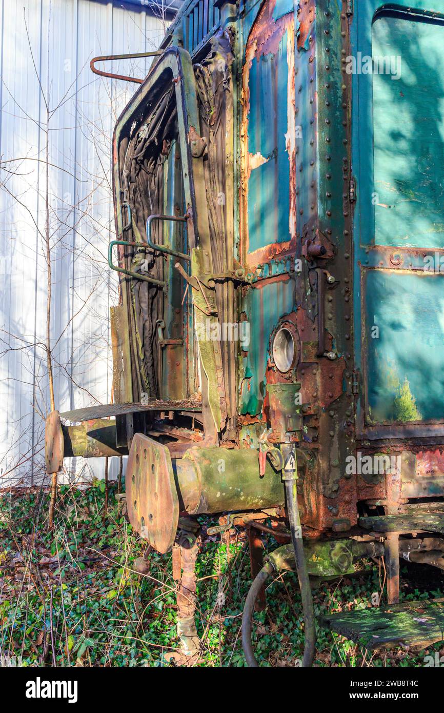 Side view of connecting buffers and fallen door of a dilapidated, rusty ...