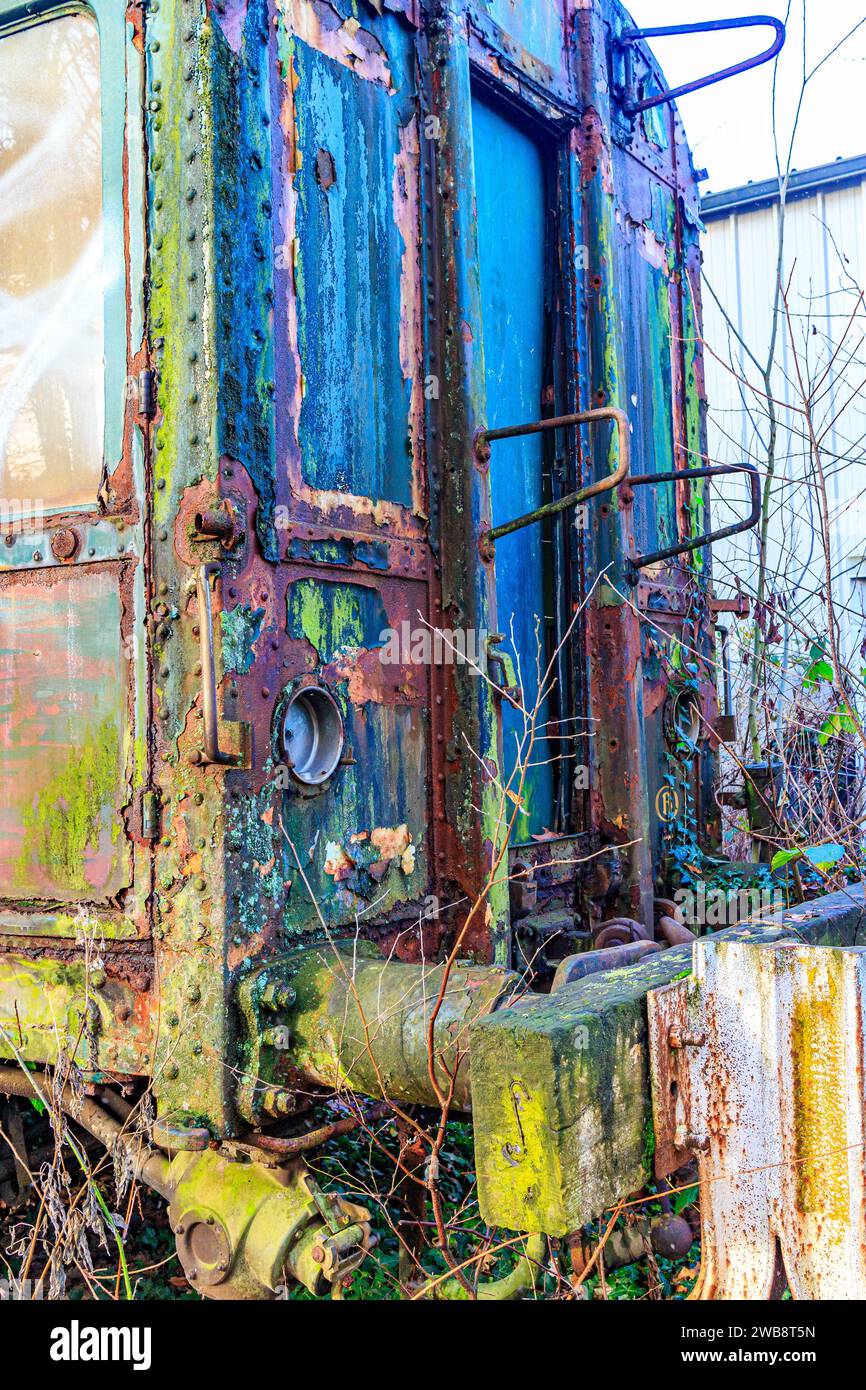 Side perspective of dilapidated, rusty, damaged and abandoned train ...