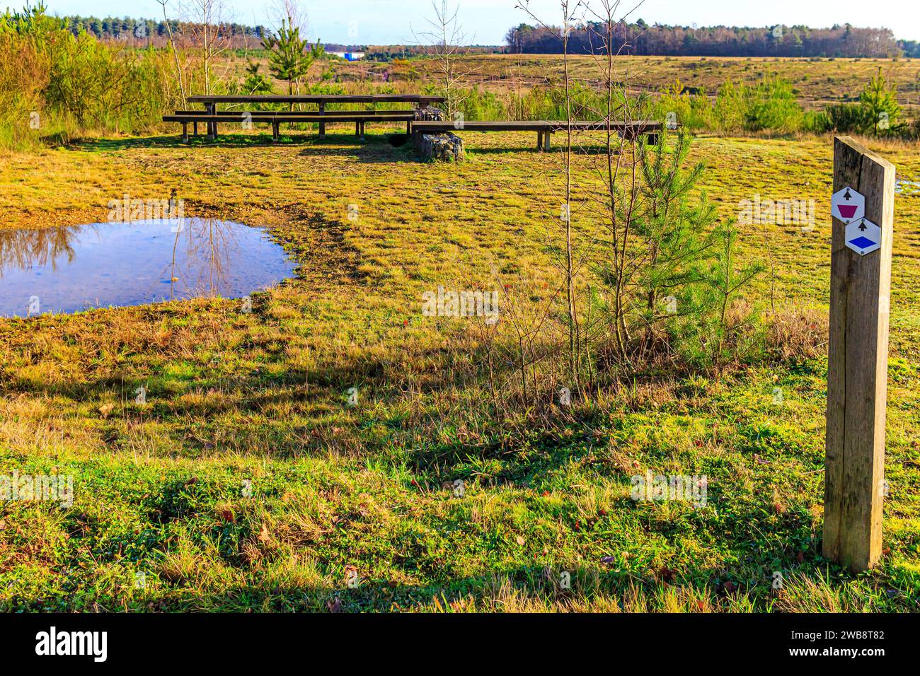 Hiking route signage at rest area and viewpoint on plain, trees in ...