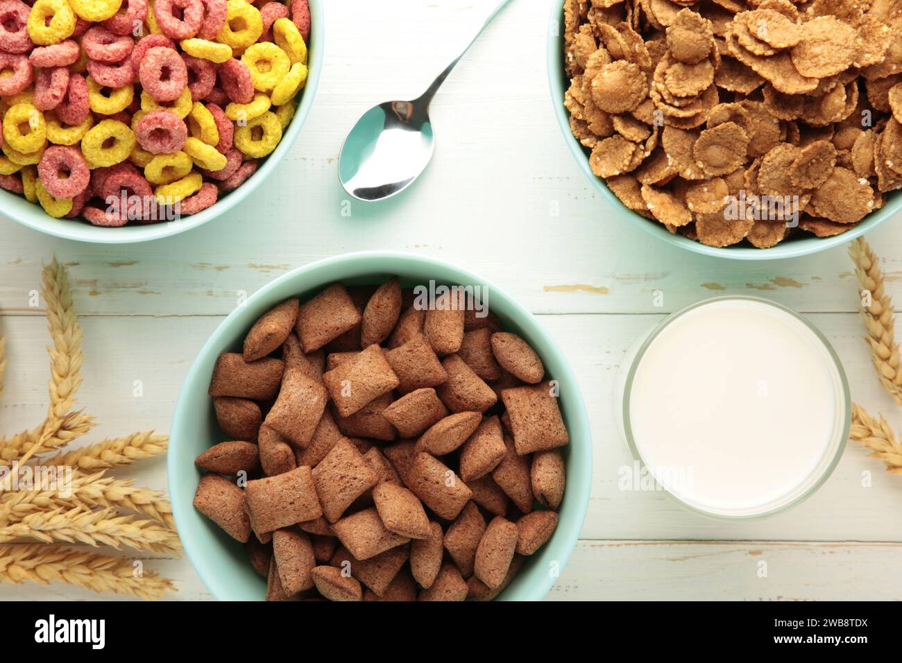 Variety of cereals in blue bowls, quick breakfast and milk on white ...