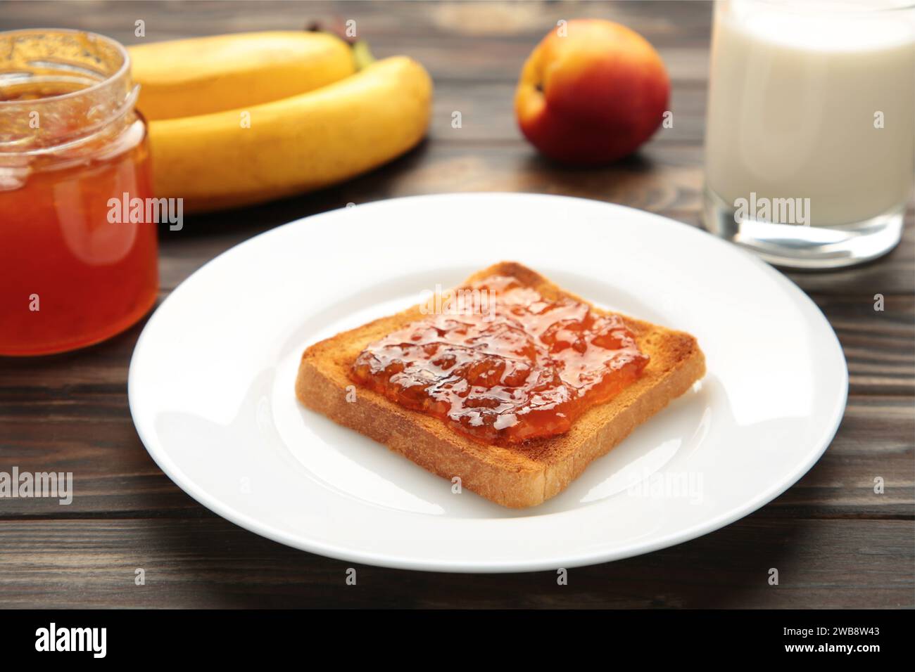 Sweet toasts with jam and fruit with milk for breakfast. Top view Stock ...