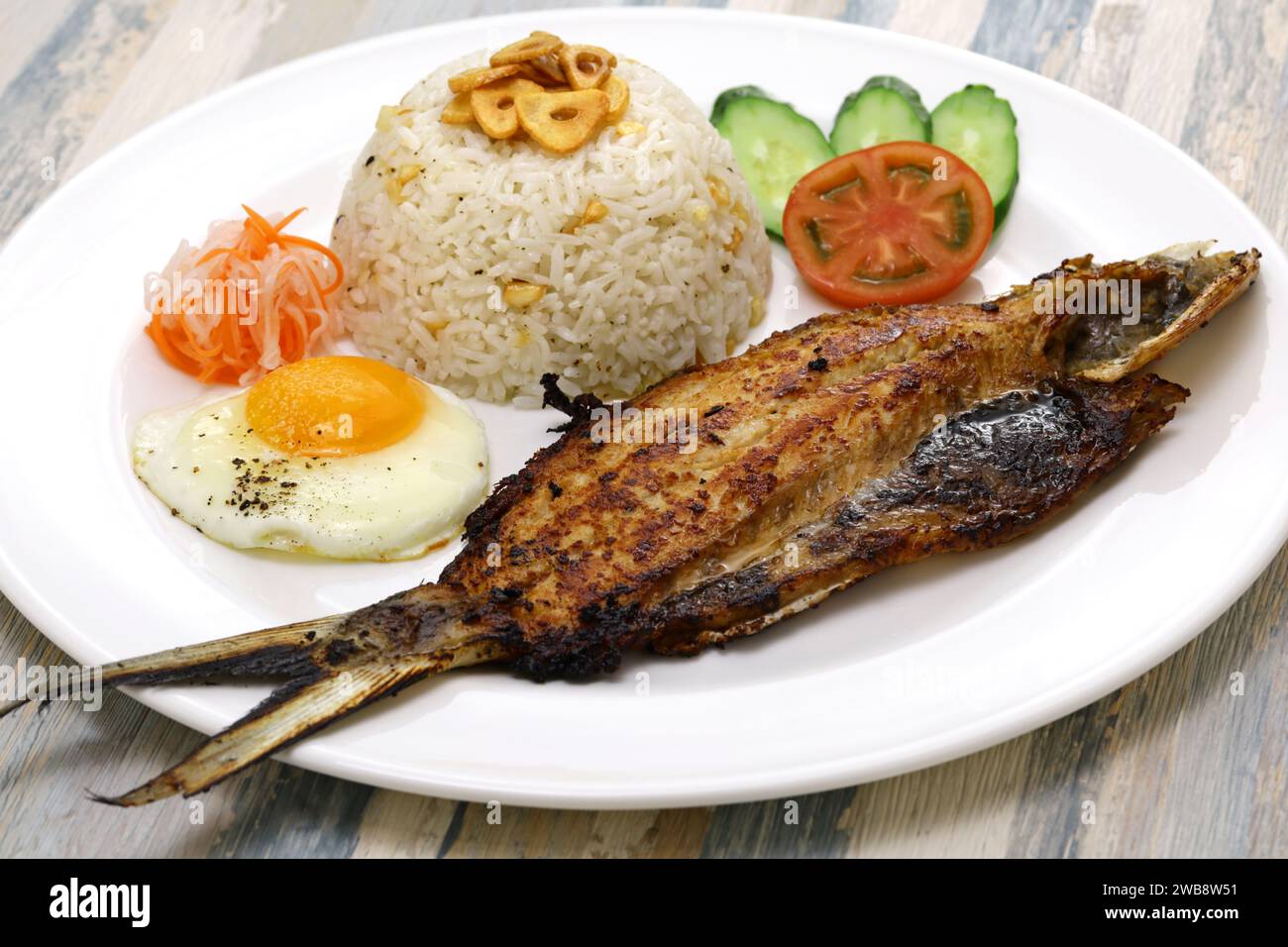 Bangsilog (milkfish, fried rice, and egg), traditional Filipino breakfast Stock Photo - Alamy