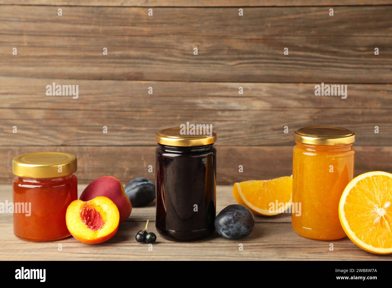 Homemade fruit jam in the jar on grey wooden background Stock Photo - Alamy