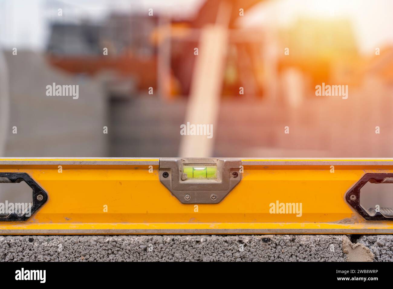 Close-up of the yellow bubble spirit level on top of the block wall on ...