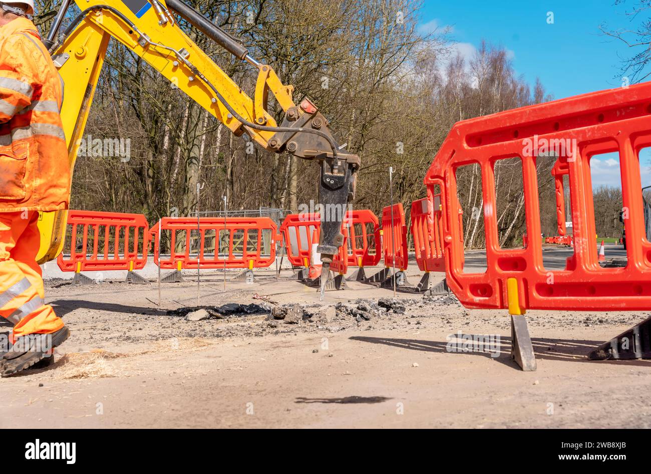 Excavator breaking and drilling the concrete and road surface. Large ...