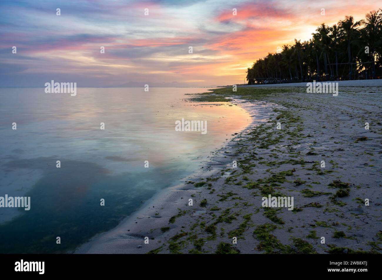 A scenic view of sunset at Dumaluan Beach, Panglao Island, Bohol ...