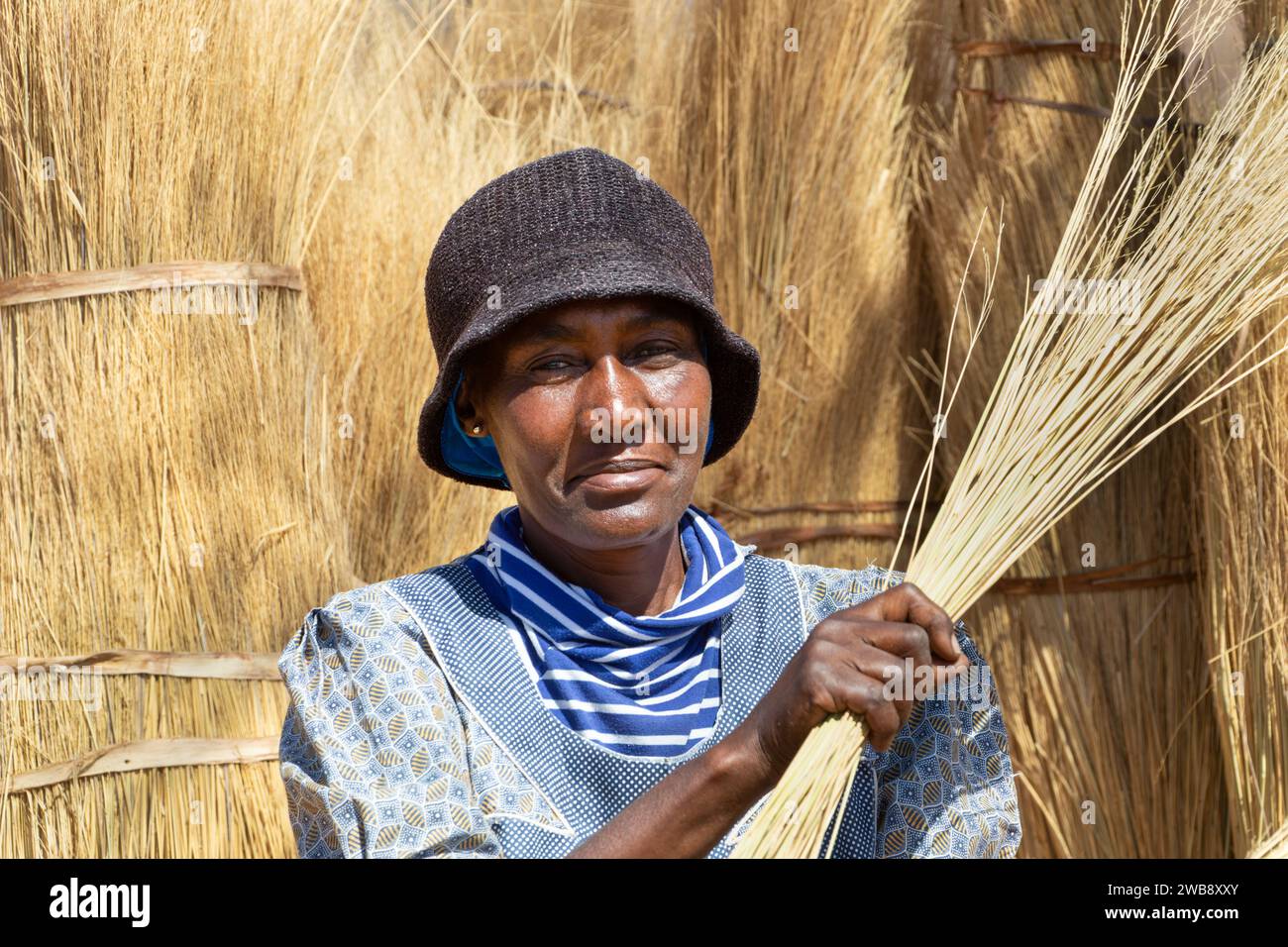thatch work , portrait of a village african woman making bundles to ...