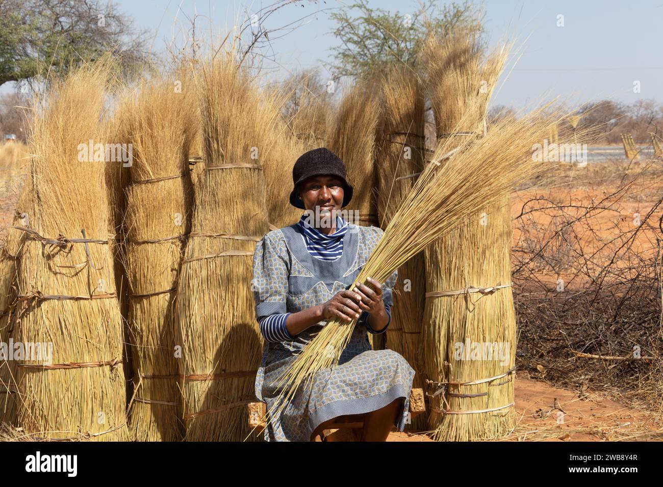thatch work , portrait of a village african woman making bundles to ...