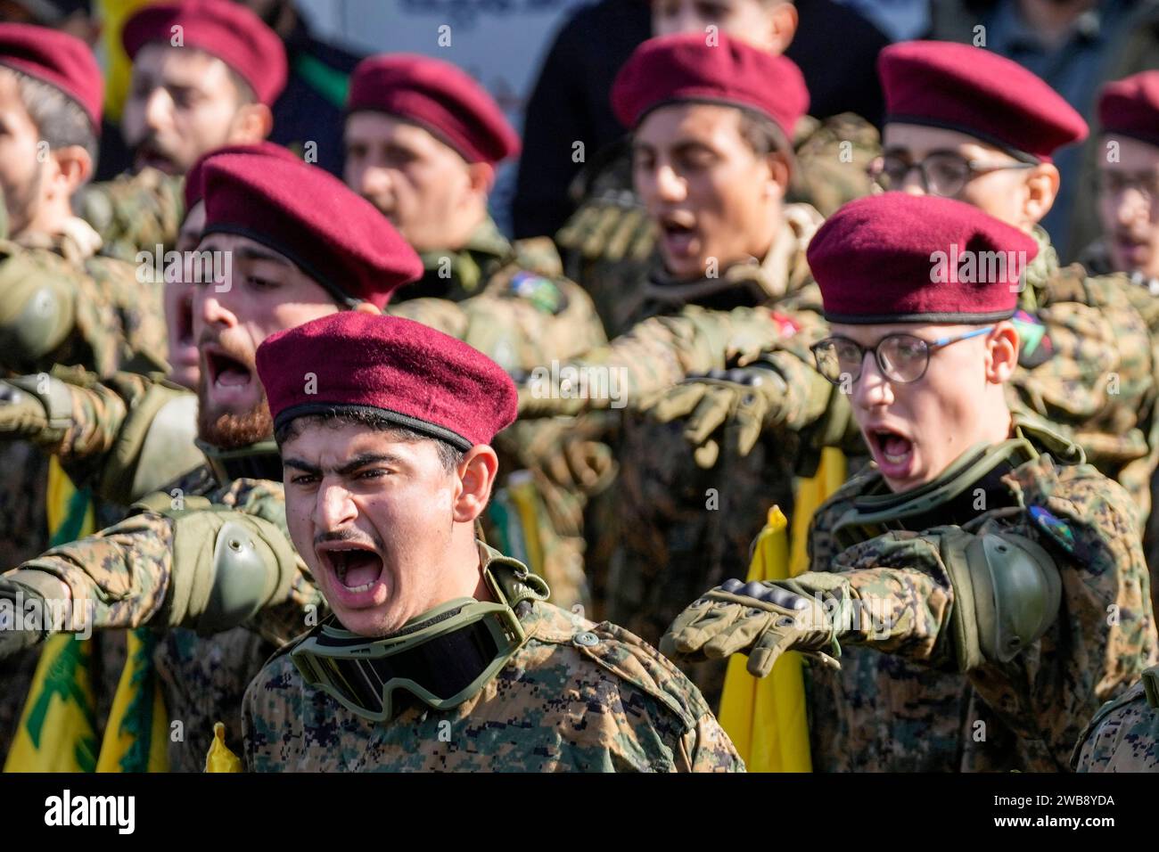 Hezbollah fighters chant slogans as they attend the funeral procession ...