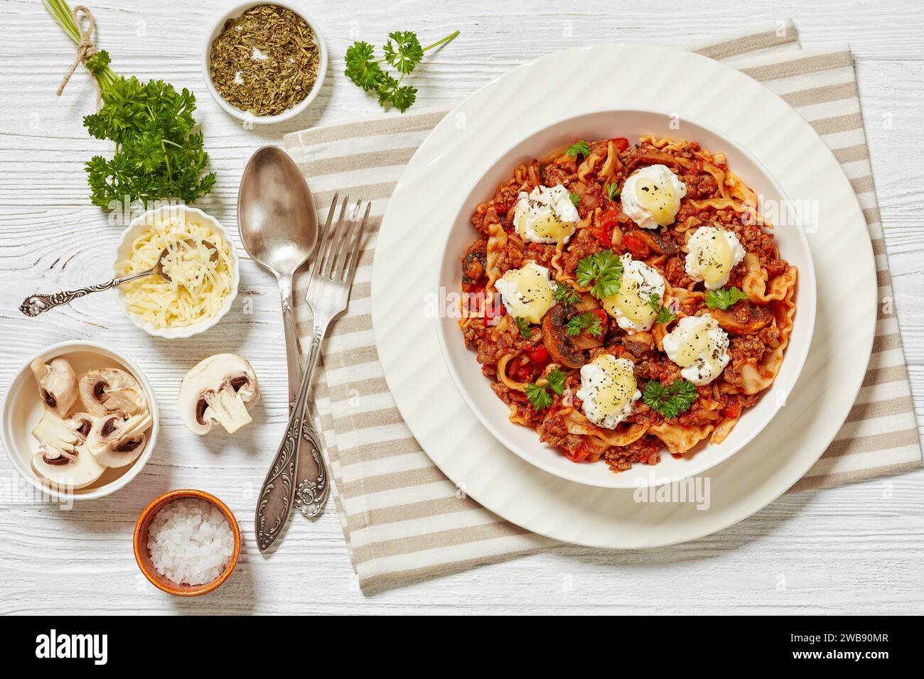 Lasagnette with beef ragu, mushrooms and ricotta cheese in white bowl ...