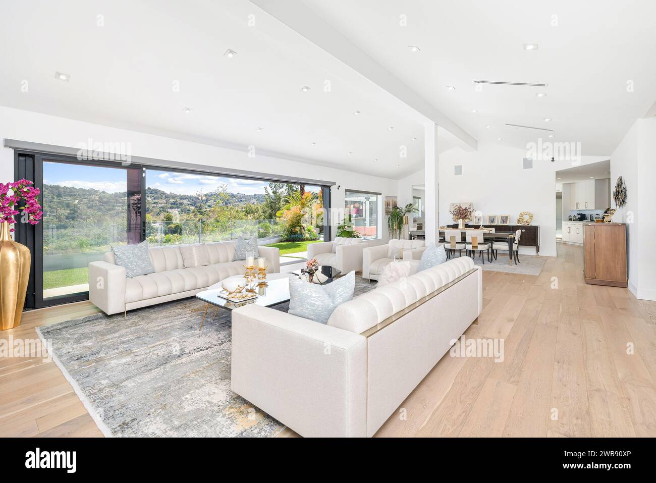 This modern living room with wood floors and high ceilings boasts a ...