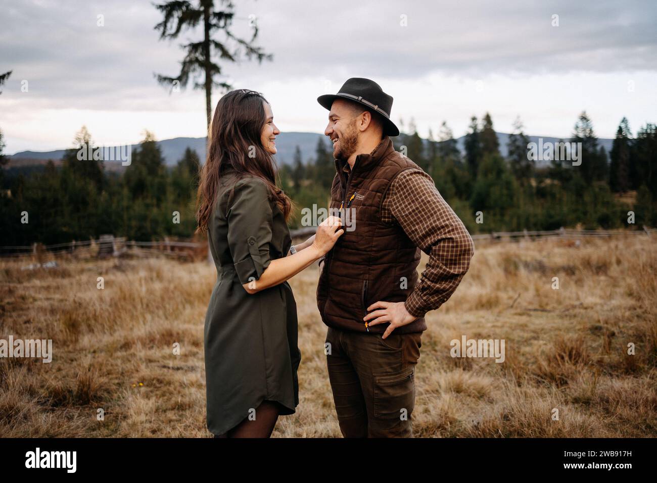 Young lovely couple, the hunter and his lady happily talk to each other ...
