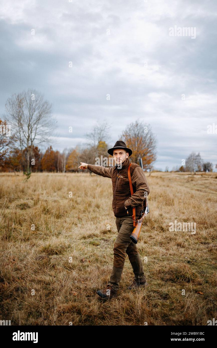 The hunter shows the direction with his finger Stock Photo - Alamy