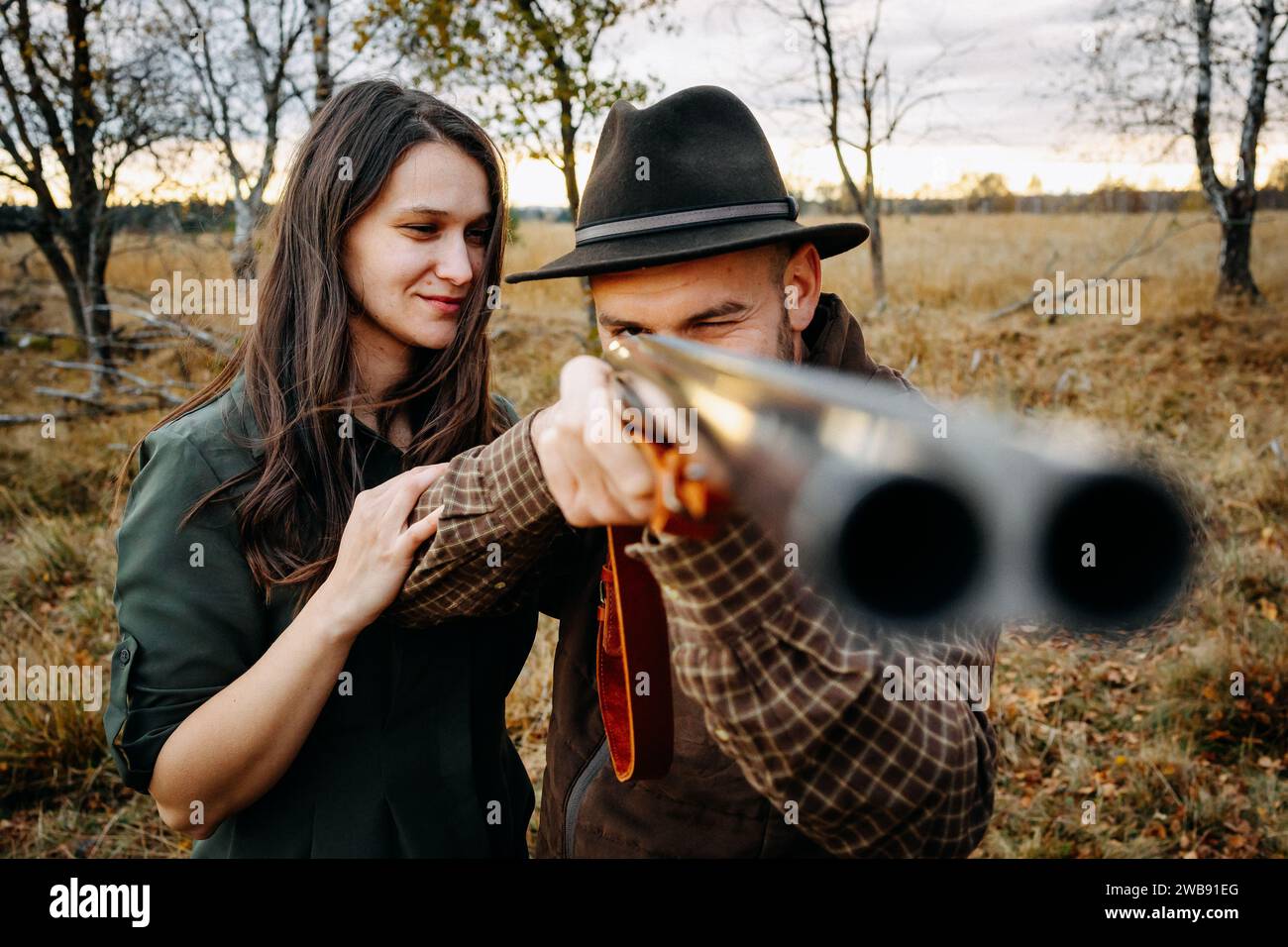 The hunter and his lady, the hunter aims his rifle Stock Photo - Alamy