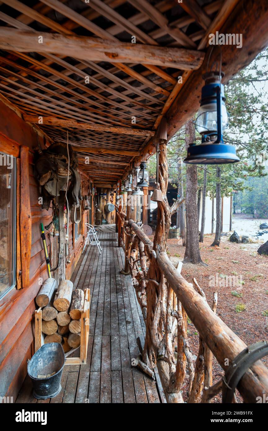 An outdoor porch of a rustic log cabin in the woods. High Desert ...