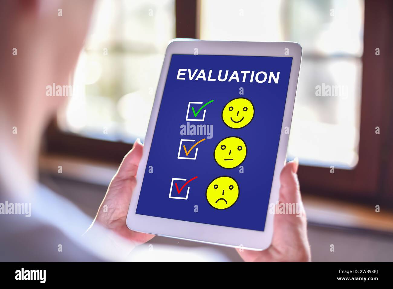 Tablet screen displaying an evaluation concept Stock Photo - Alamy