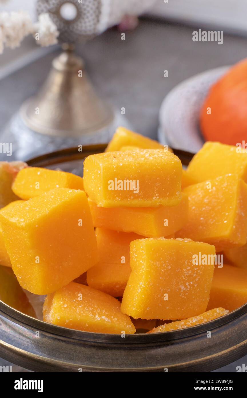 Homemade pumpkin and agar-agar gummies. Orange jelly candies served on ...