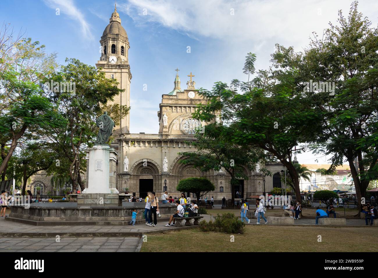 A bustling crowd of people is seen walking around a tall, modern ...