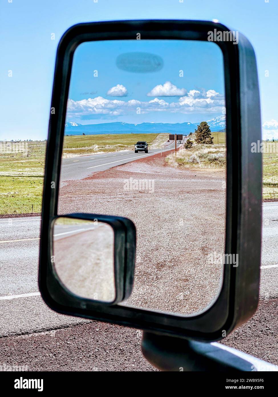 An aerial view of a car driving down a street with a view of the ...
