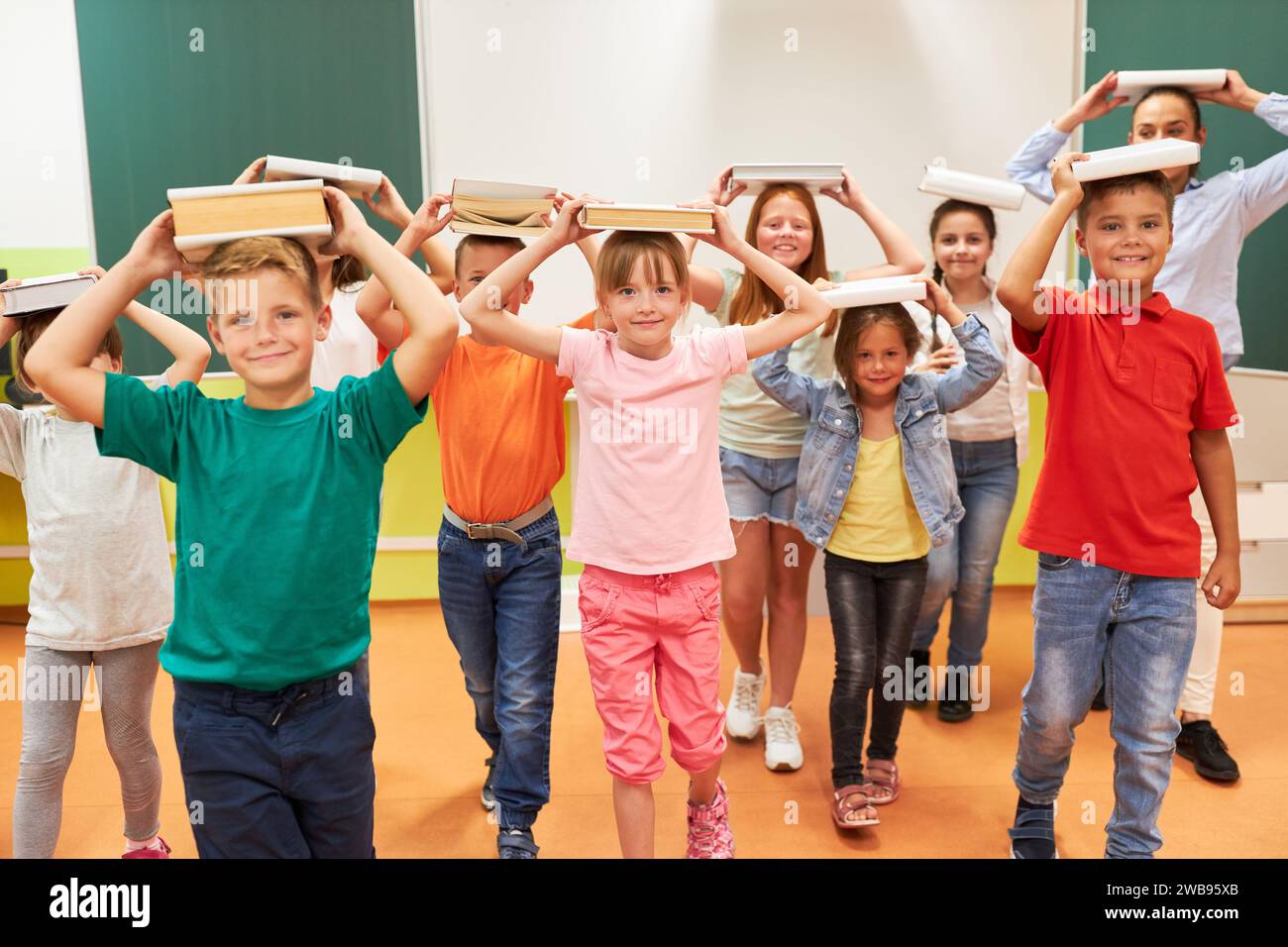 Woman balancing books head hi-res stock photography and images - Alamy