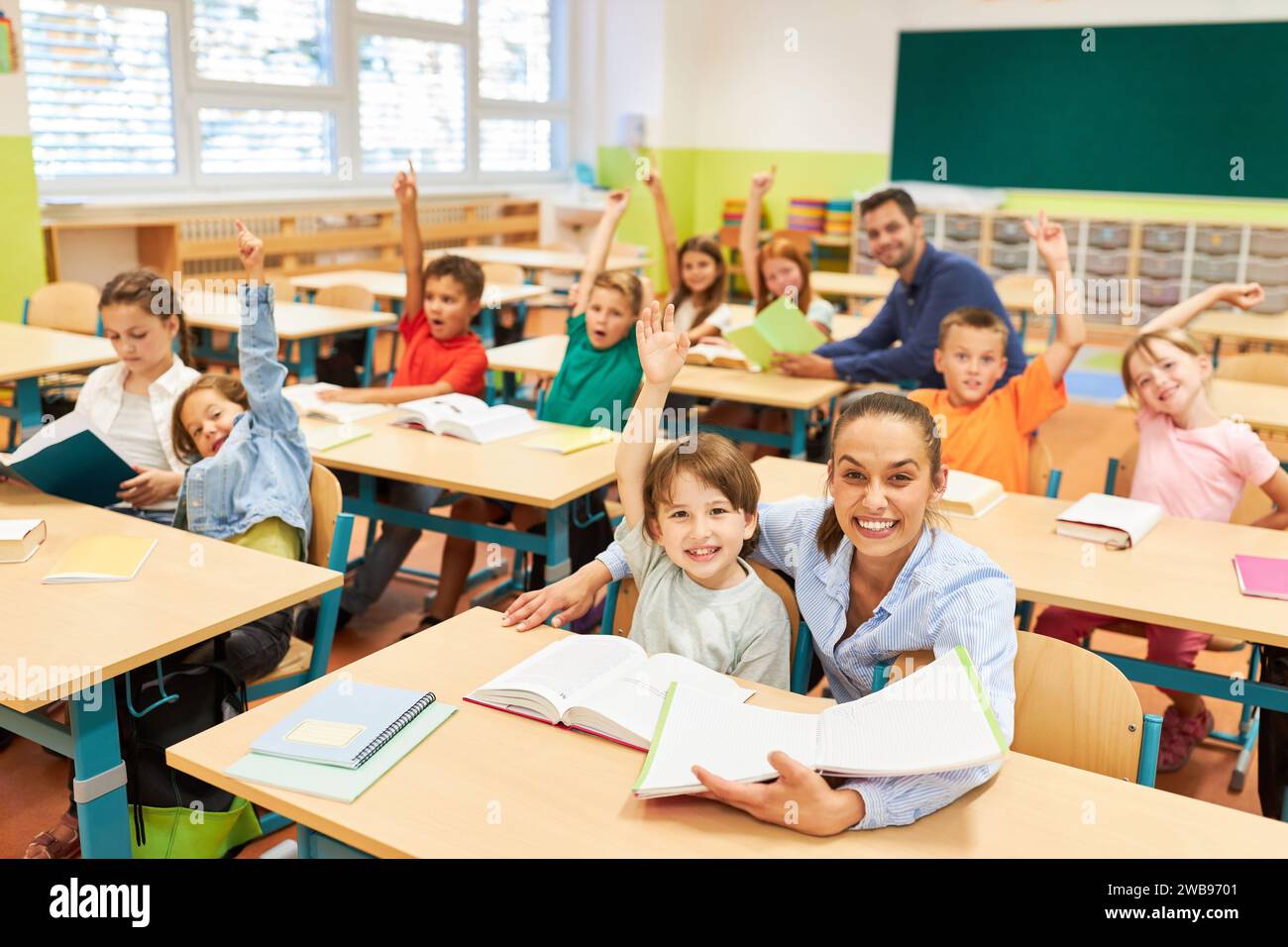 Schoolkid hand raised in classroom hi-res stock photography and images ...
