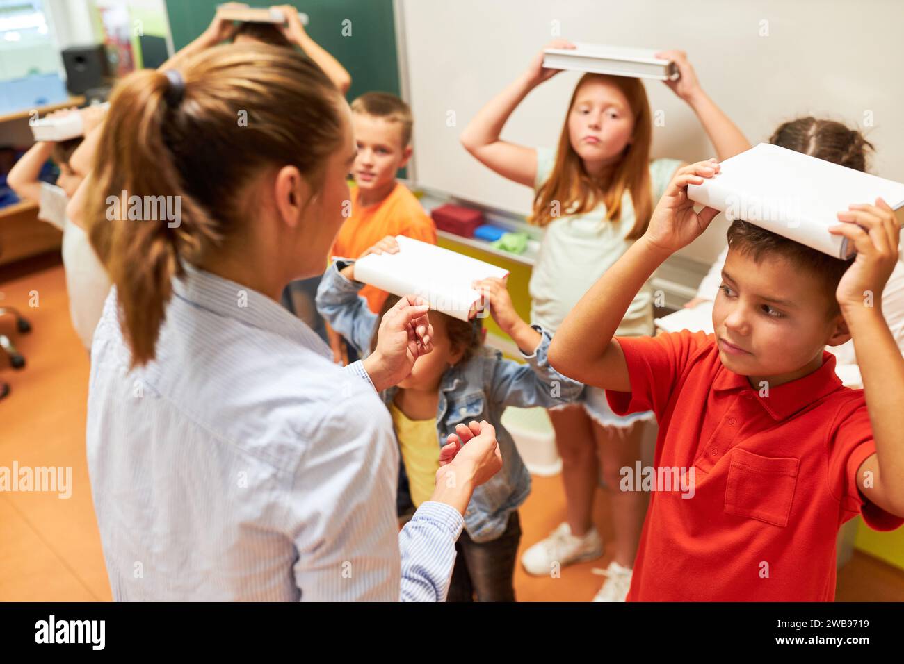 Woman balancing books head hi-res stock photography and images - Alamy