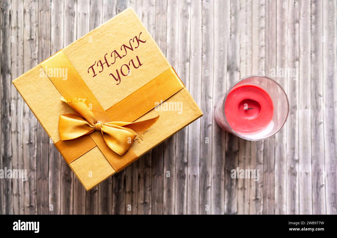 thank you message on gift box and wooden background with candle Stock ...