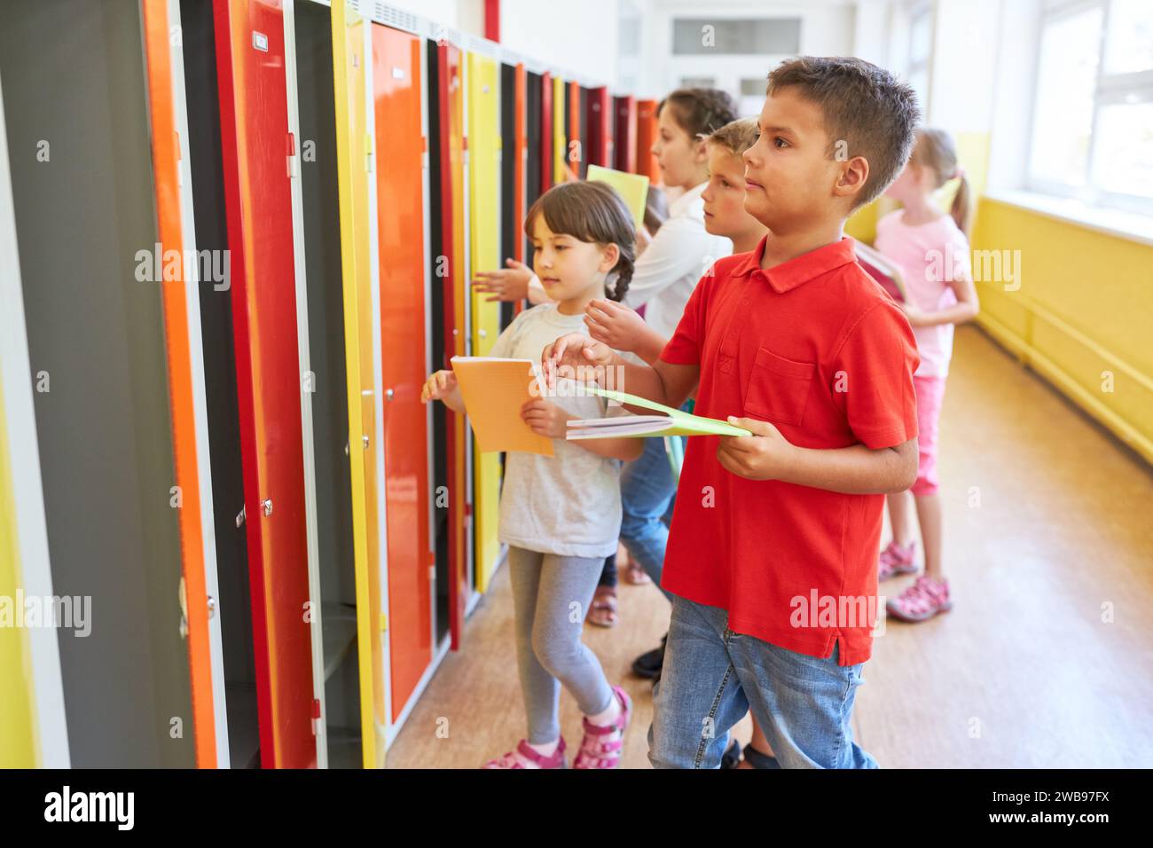 Group of elementary schoolkids keeping books in lockers Stock Photo - Alamy