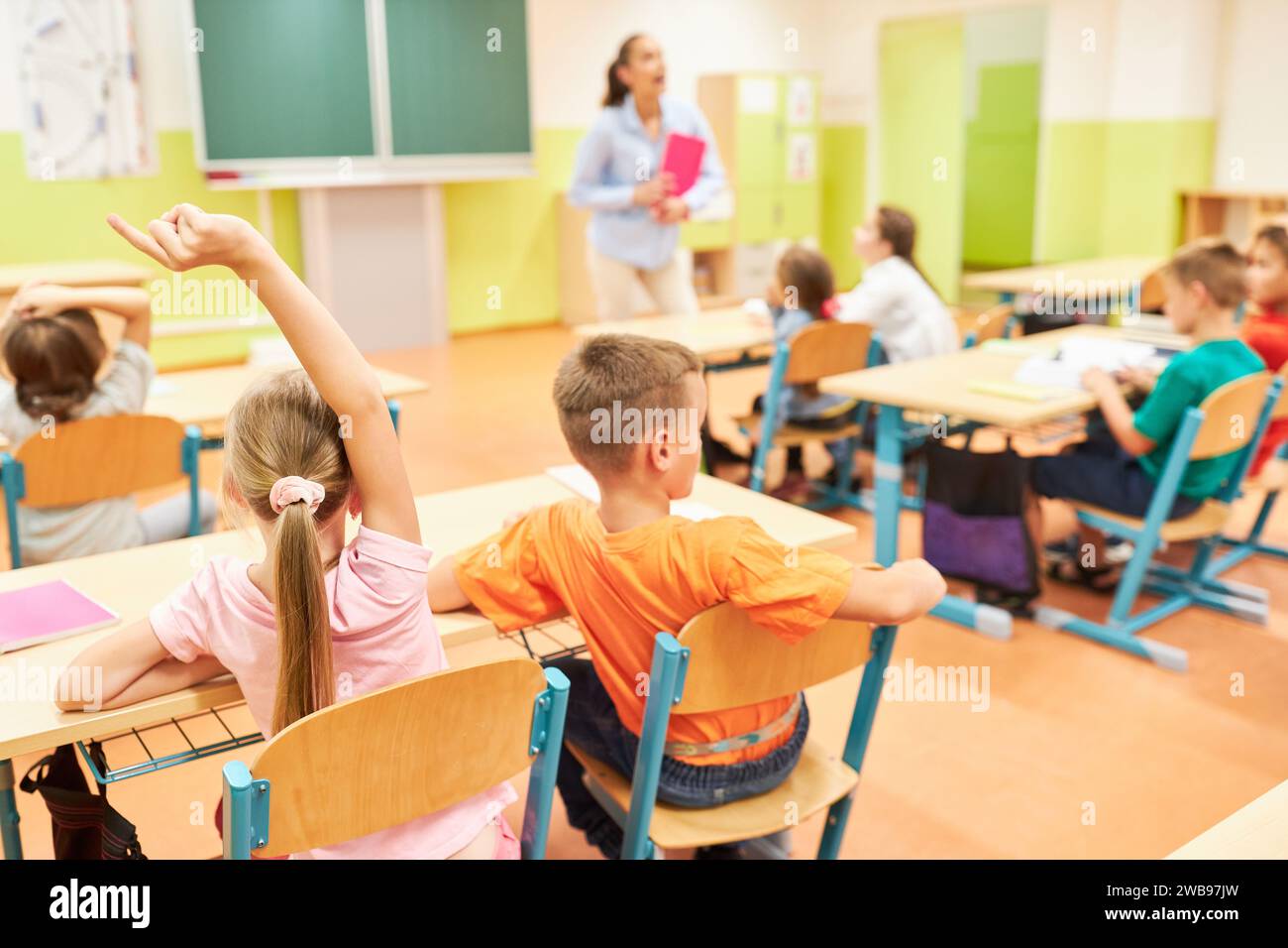 Group of elementary school children sitting together during lecture in ...