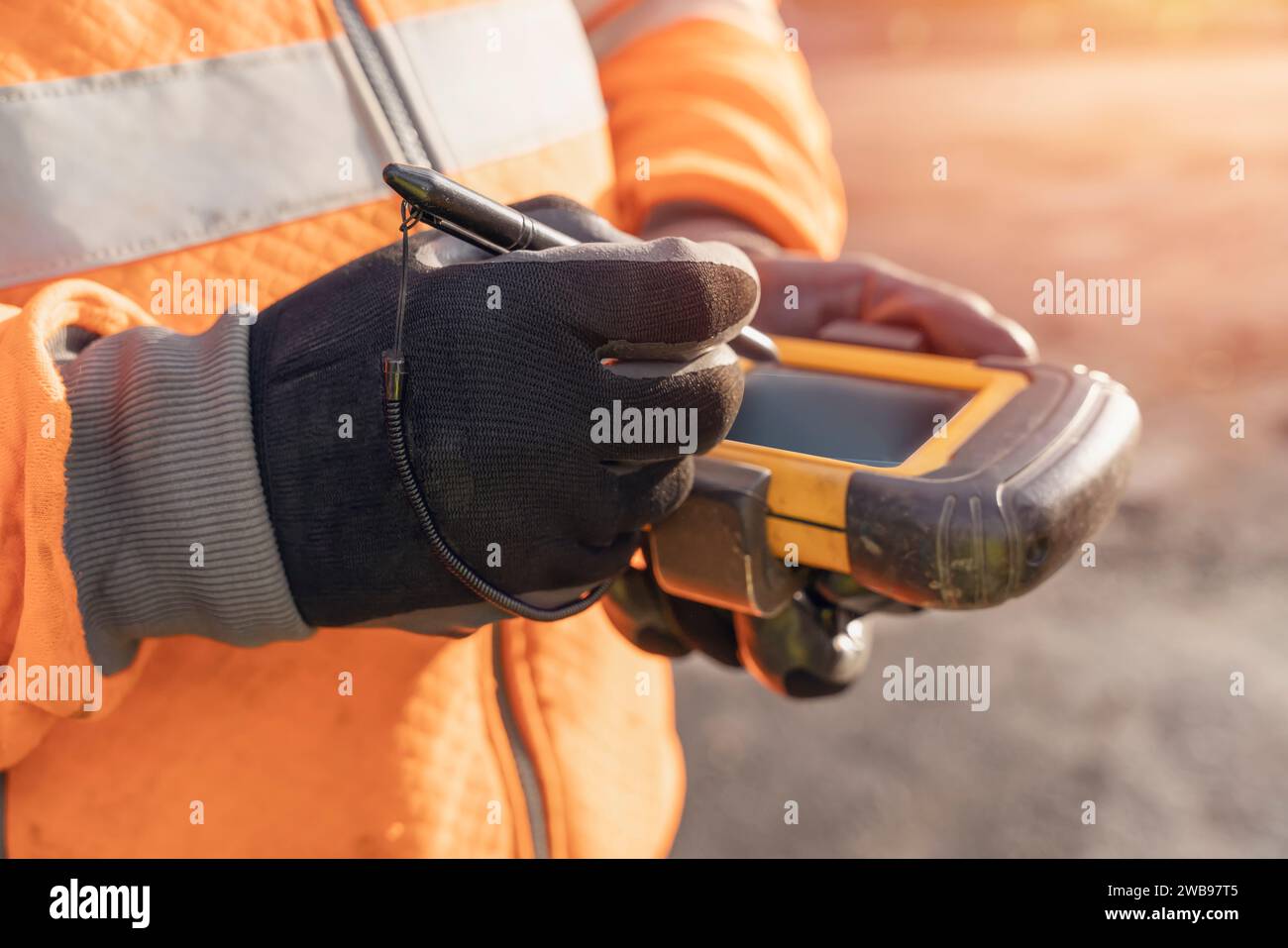 Site engineer operating his touch screen controller instrument during ...