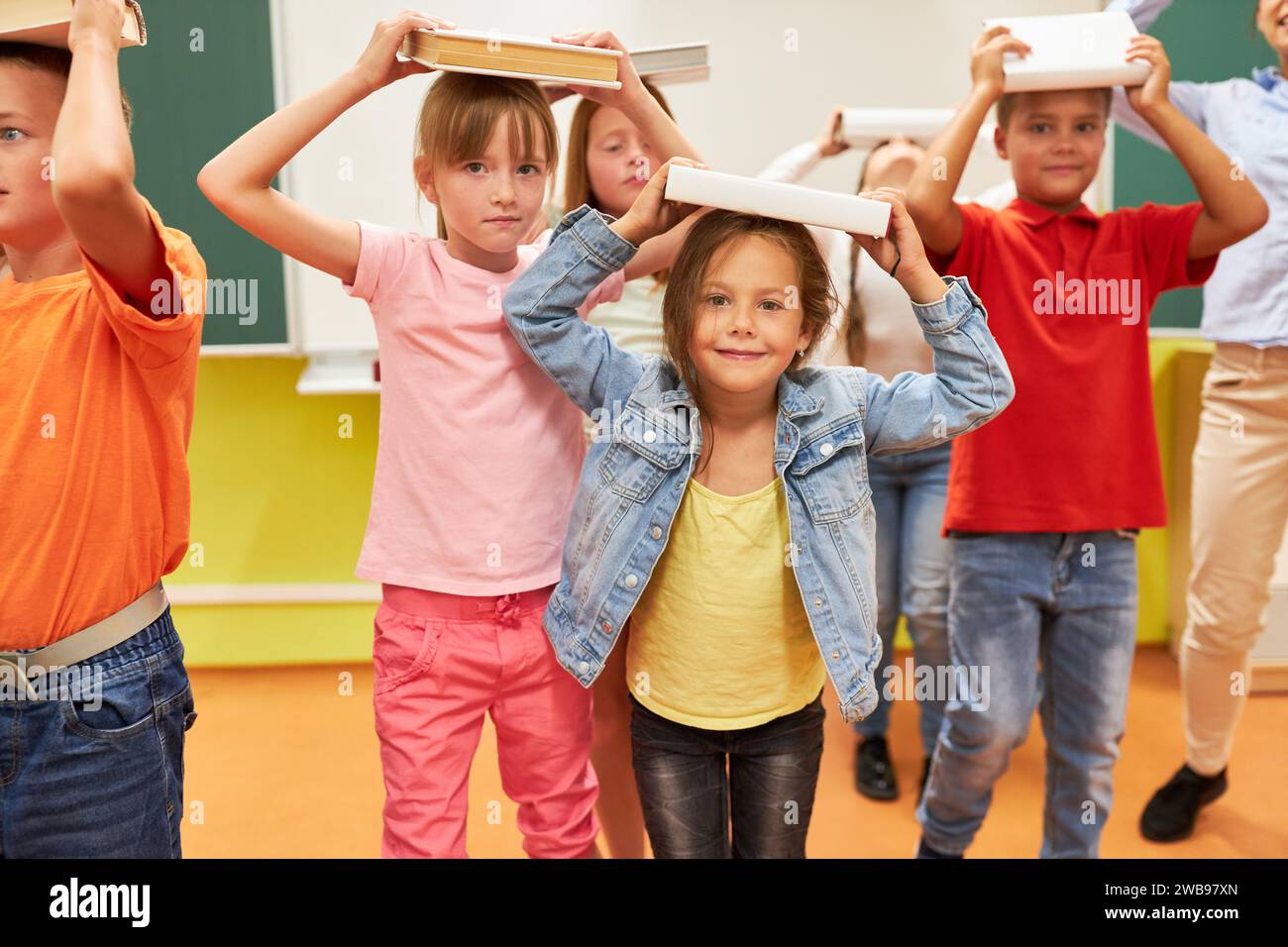 Woman balancing books head hi-res stock photography and images - Alamy