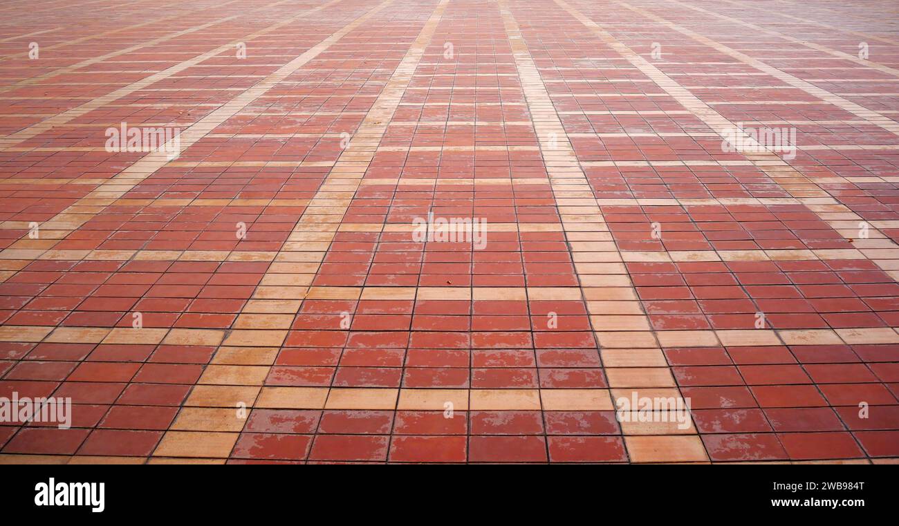 Red brick tile floor neatly arranged on a patterned texture background ...