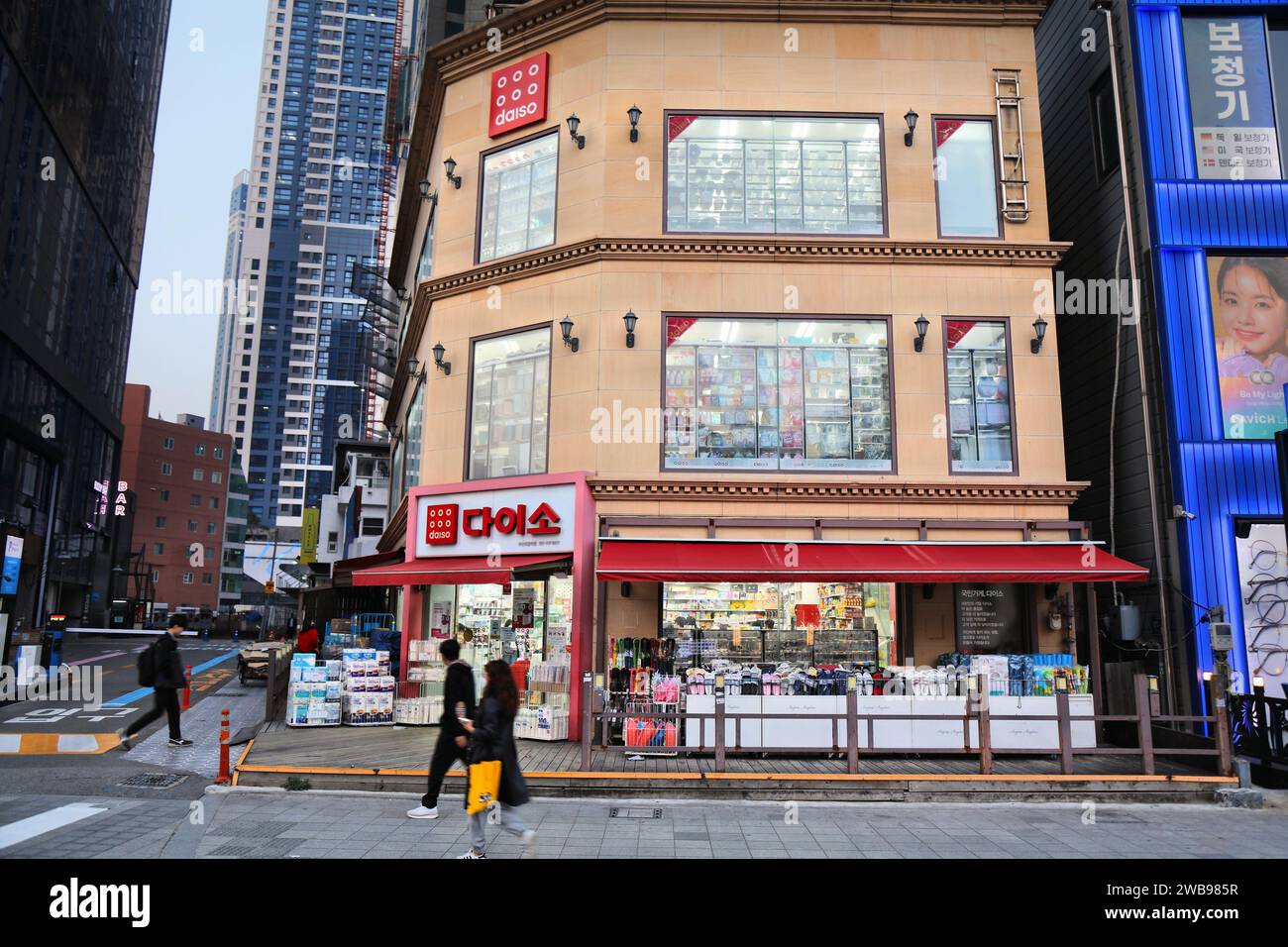 BUSAN, SOUTH KOREA - MARCH 29, 2023: People walk by Daiso discount ...