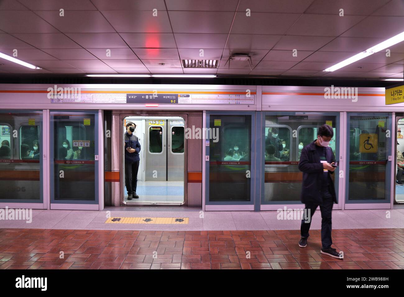 BUSAN, SOUTH KOREA - MARCH 29, 2023: People board a subway train at ...