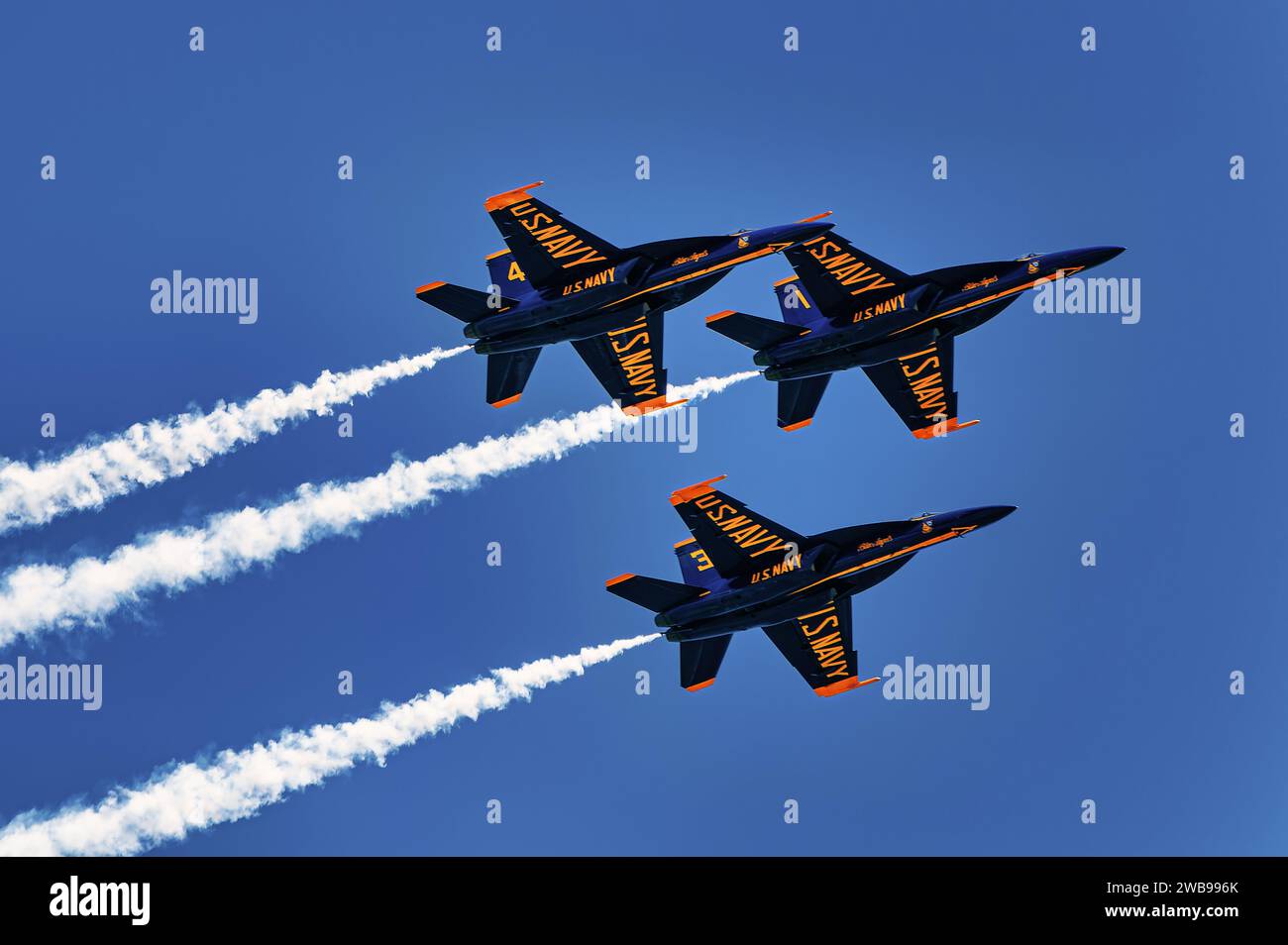 A group of military jets in formation performing in the sky at an air ...
