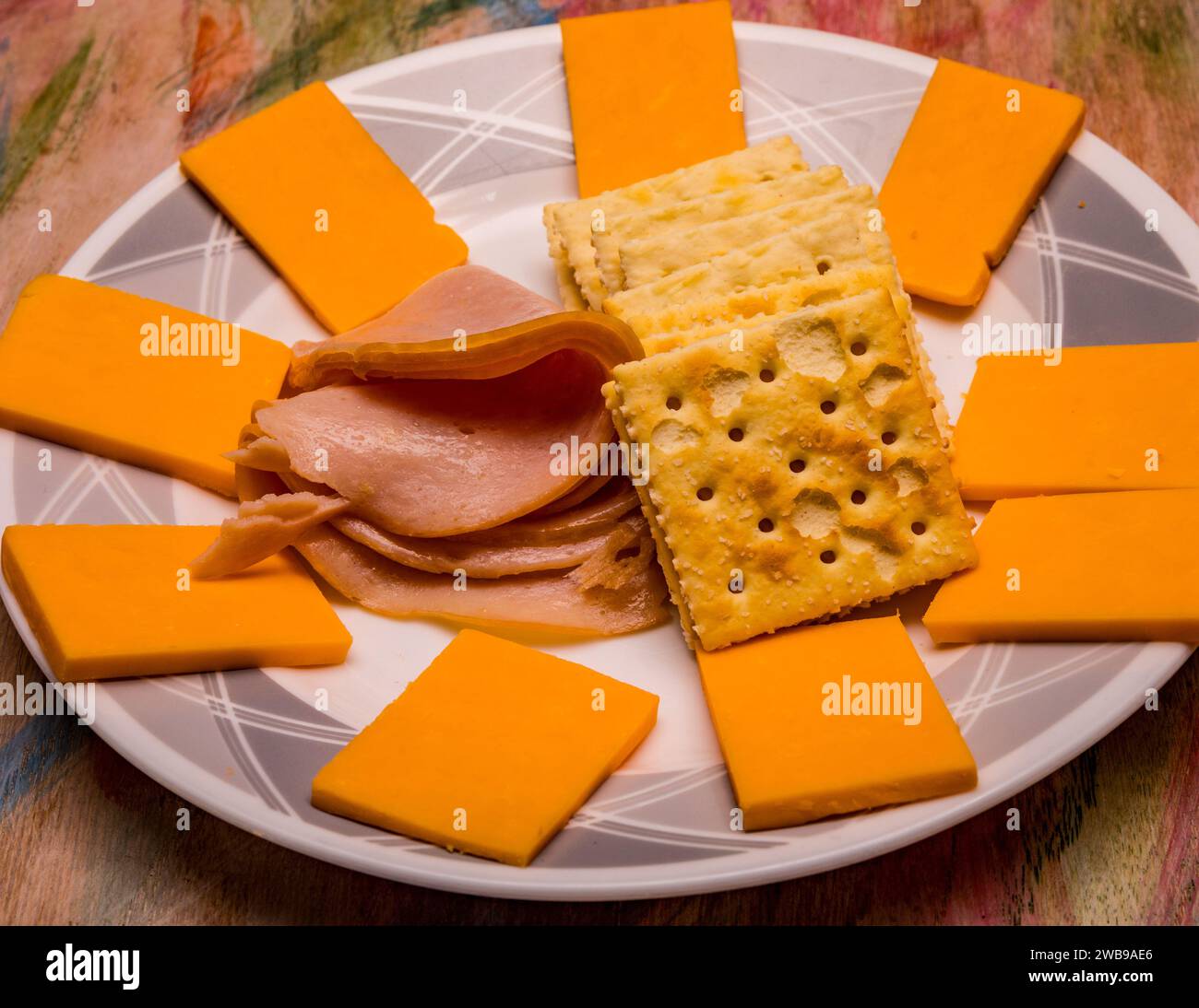 A snack plate of cheddar cheese with smoked turkey deli meat and soda ...