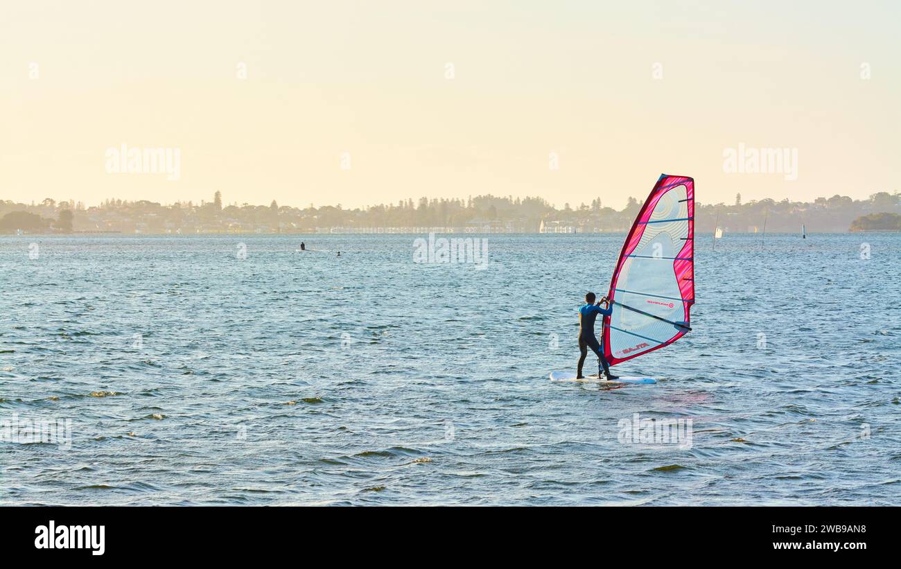 A man practising windsurfing/sailboarding with a sailboard on the Swan ...