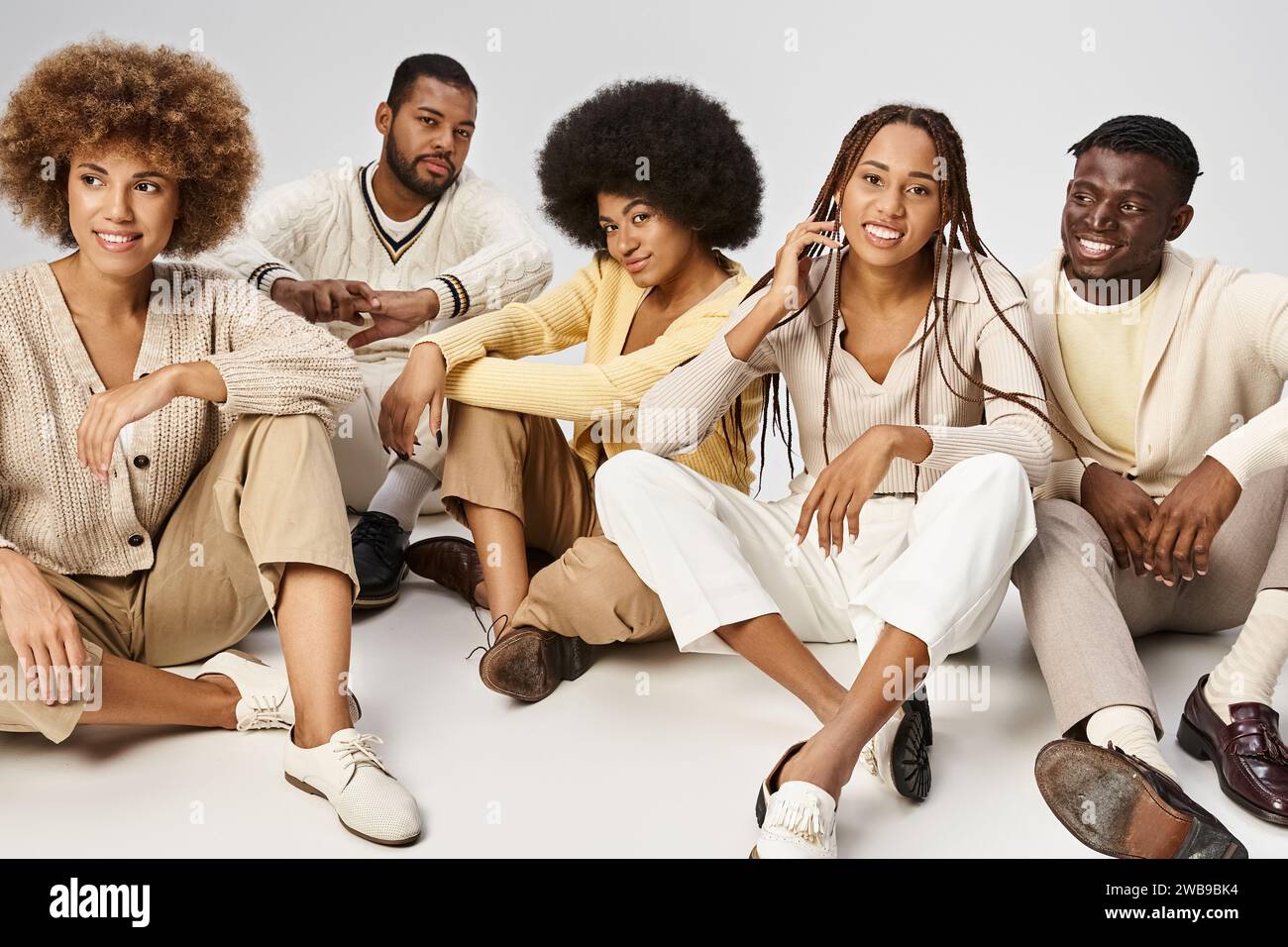 group of optimistic african american people in casual attire sitting on ...