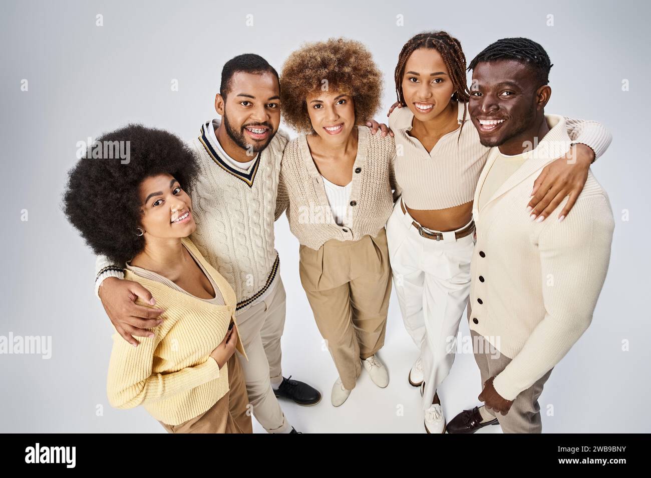 top view of cheerful african american people bonding and hugging on ...
