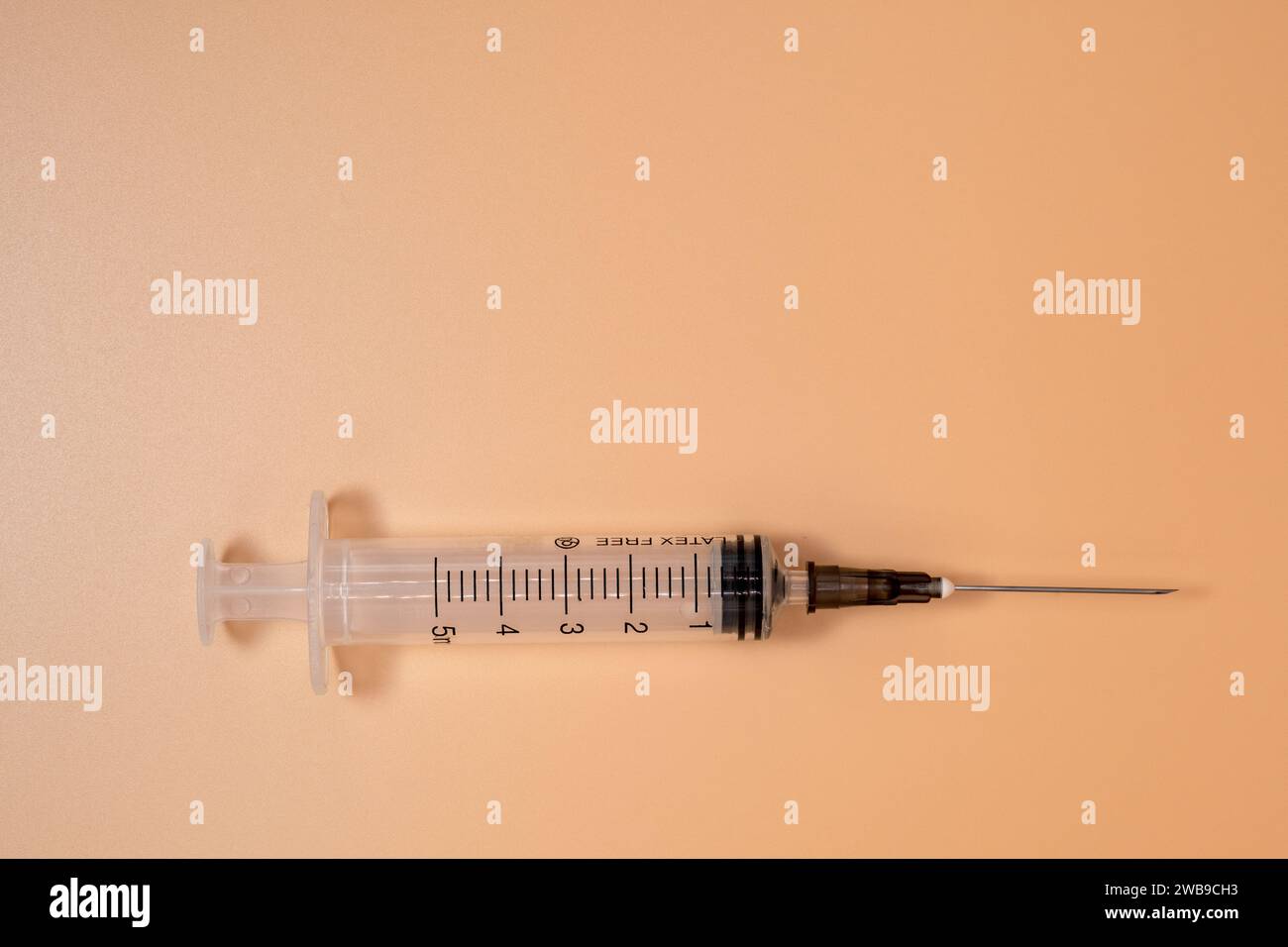 Empty 5ml syringe with needle on peach background. Copy Space Stock ...
