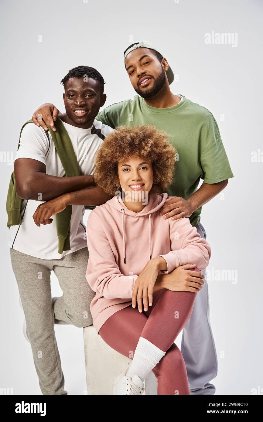 cheerful african american friends looking at camera on grey background ...