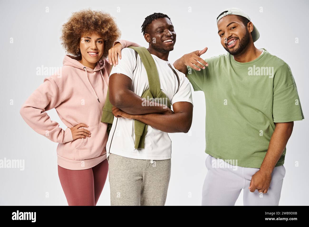 positive african american friends posing together on grey background ...