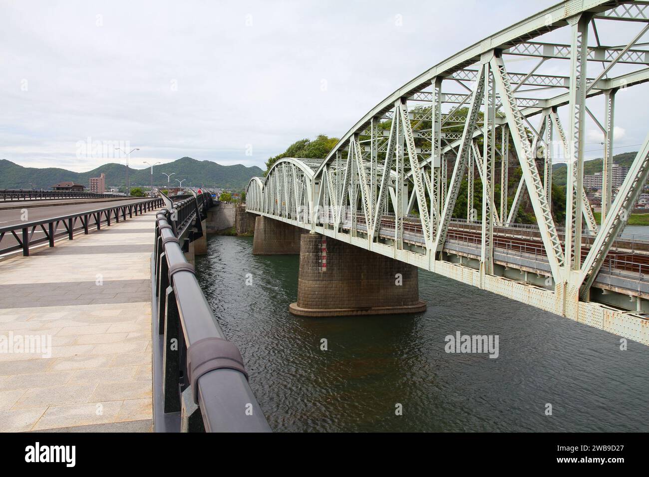 Inuyama, Japan. Road bridge and railway bridge over Kiso river, side by ...