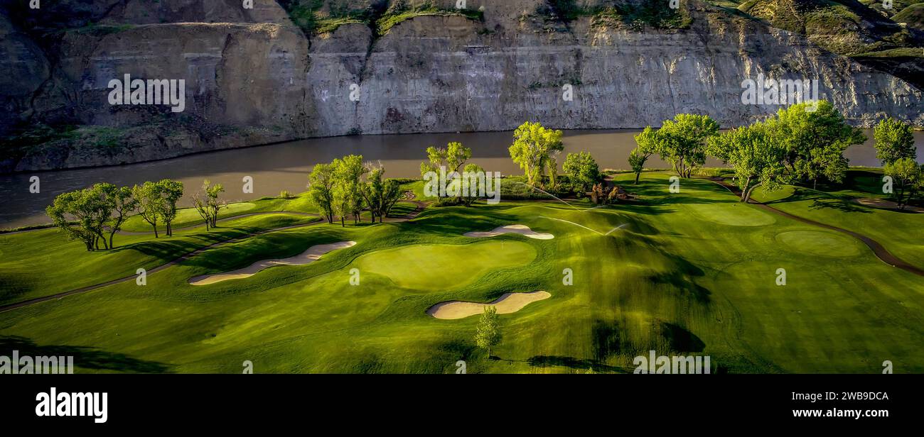 A scenic landscape featuring a cascading waterfall, lush golf course ...